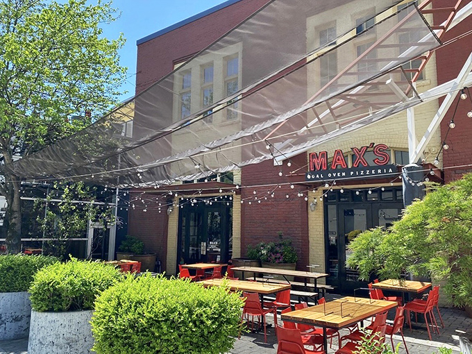 Max's outdoor seating area, draped with twinkling lights, sets the stage for coal-fired pizza magic under the Georgia sky.