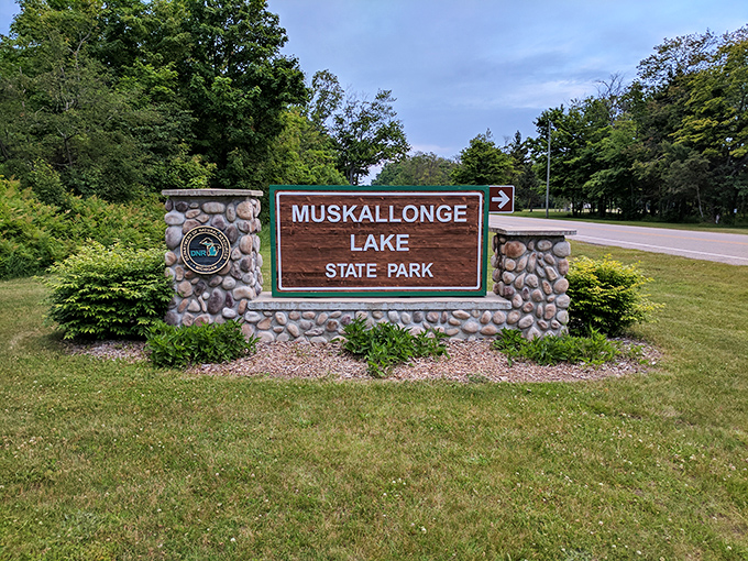 The welcoming sign at Muskallonge Lake State Park promises adventures between two bodies of water&mdash;like getting a two-for-one deal on nature.