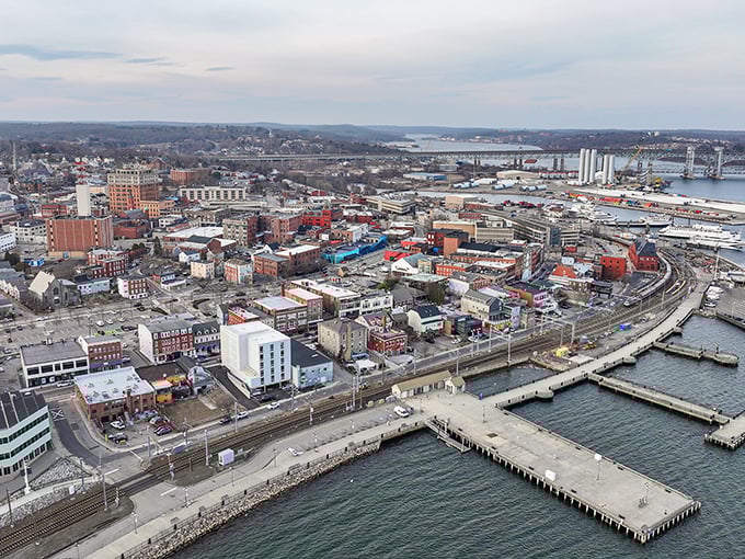 New London's harbor bustles with boats beneath the iconic bridge, offering maritime charm at landlubber prices.