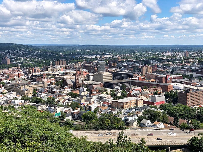 A panoramic view of the city nestled among green hills - industrial heritage with a surprisingly scenic backdrop.