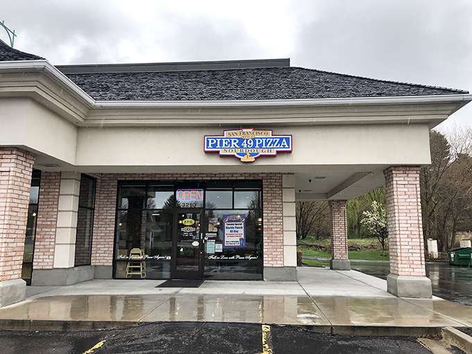 Pier 49's simple storefront proves great pizza doesn't need fancy packaging - just a sign and a promise of deliciousness.