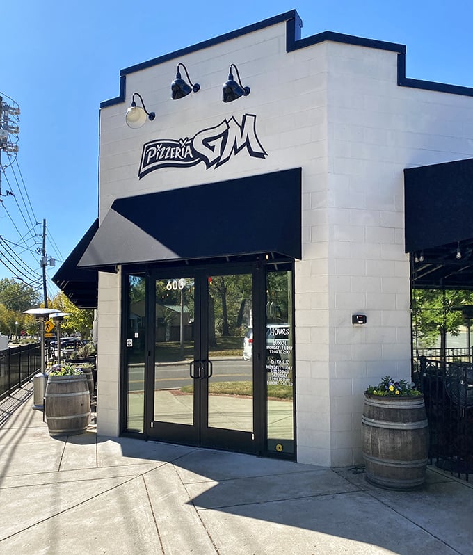 Pizzeria G.M.'s sleek white exterior and barrel planters hint at the perfect marriage of tradition and modernity waiting inside.