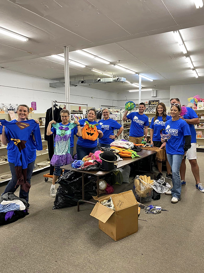 St. Vincent de Paul's volunteer crew showcases Halloween costumes with superhero enthusiasm. Their real power? Helping the community while helping your wallet.