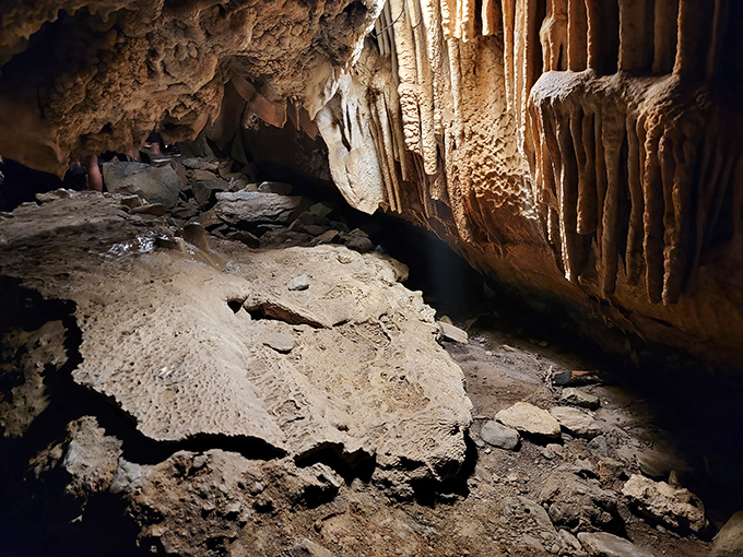 Stalactites and stalagmites create a stone forest underground. Like walking through a petrified rain shower frozen in mid-fall.