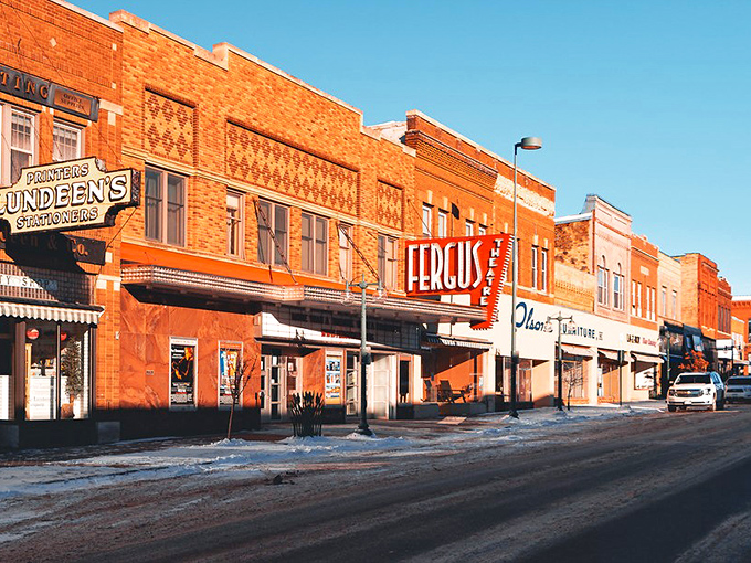 Morning light bathes Fergus Falls' brick storefronts in golden warmth, highlighting the vintage theater marquee that still draws weekend crowds.