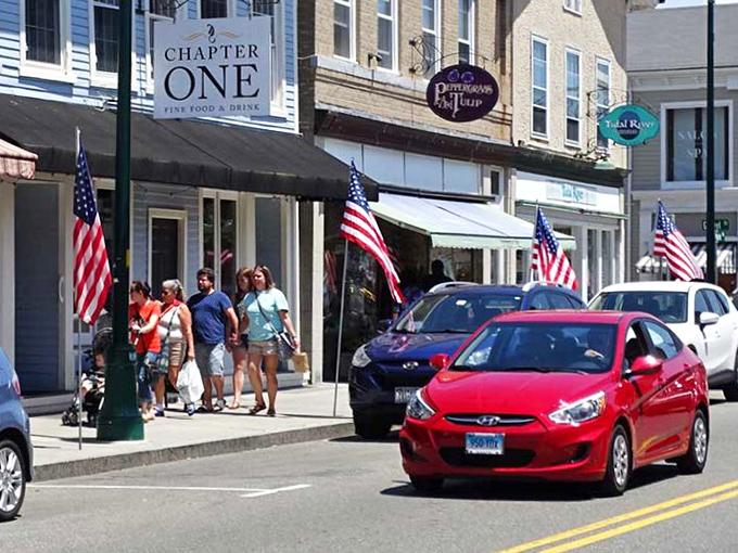 Groton's charming downtown features American flags and inviting storefronts, perfect for leisurely afternoon strolls.