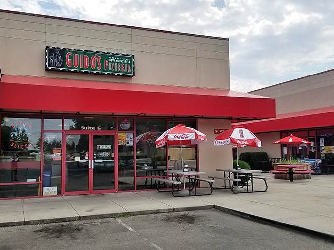 Those Coca-Cola umbrellas shade simple outdoor seating where New York-style slices taste even better in the Idaho sunshine.