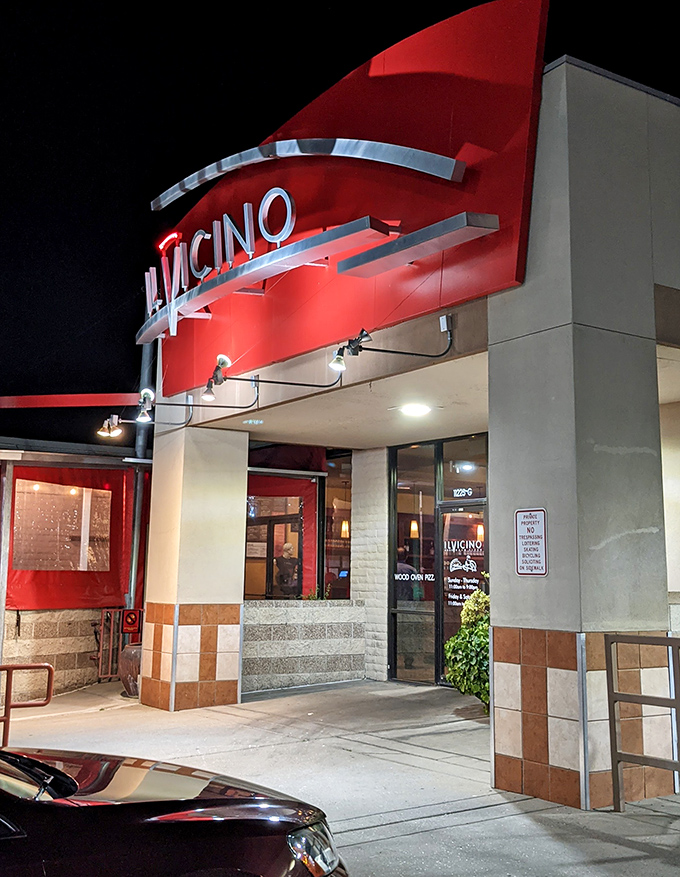 Night transforms Il Vicino into a glowing pizza palace. That illuminated sign is basically a bat signal for the hungry and discerning.