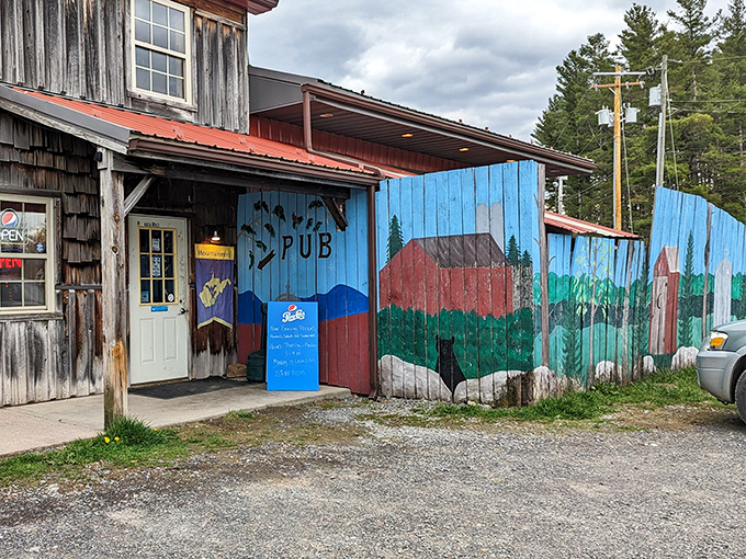The hand-painted sign and weathered wood exterior hint at the mountain magic happening inside this Thomas pizza hideaway.