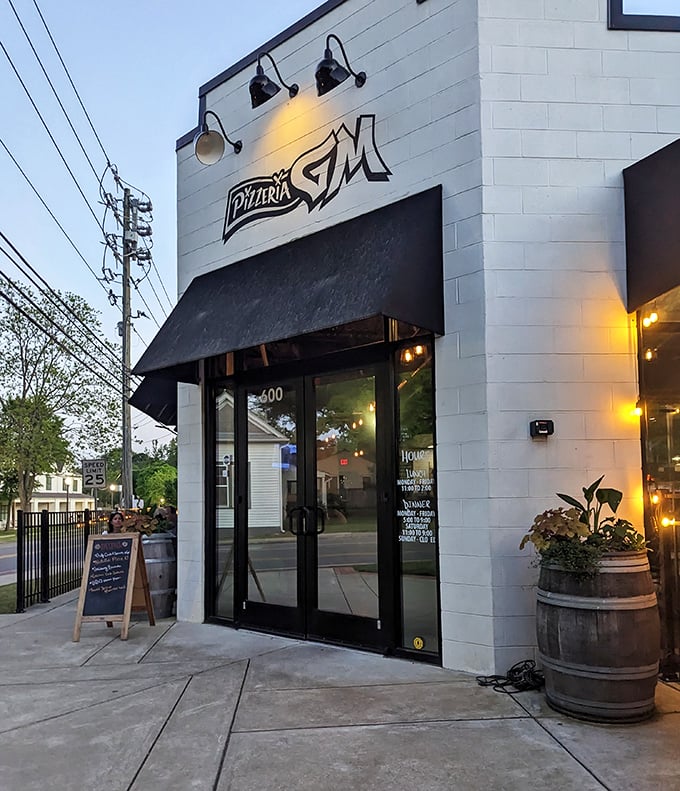 As evening falls, Pizzeria G.M.'s warm lights create an inviting glow that whispers, "Some of Alabama's best pizza happens here."