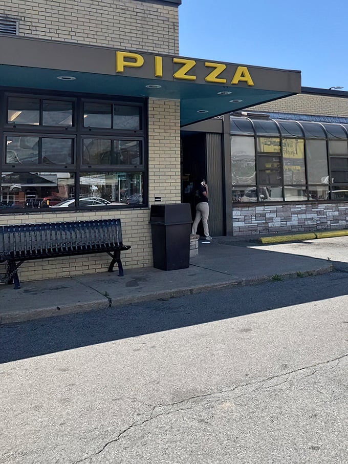 Beneath that bright blue "PIZZA" sign lies a Lawrence treasure. Tripoli proves the best things often come in the plainest packages.