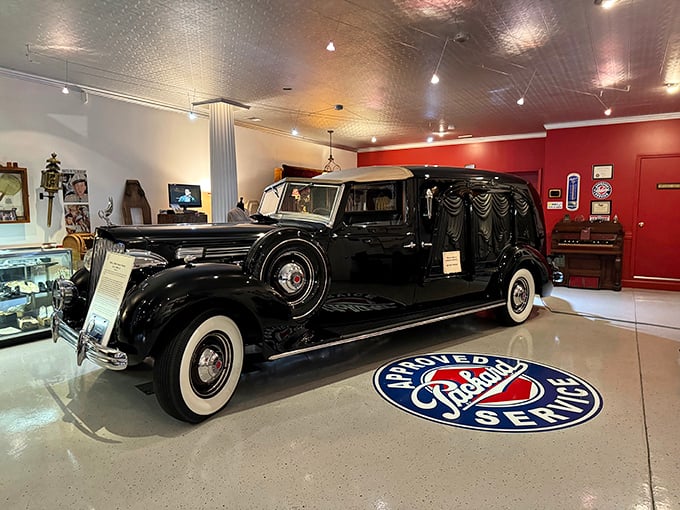 Parked on a Packard Service floor medallion, this 1938 Packard hearse represents American automotive craftsmanship at its finest&mdash;luxury transportation for the ultimate one-way trip.