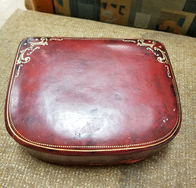 This vintage burgundy case once held someone's precious memories&mdash;now it waits for your treasures while adding a touch of old-world elegance.