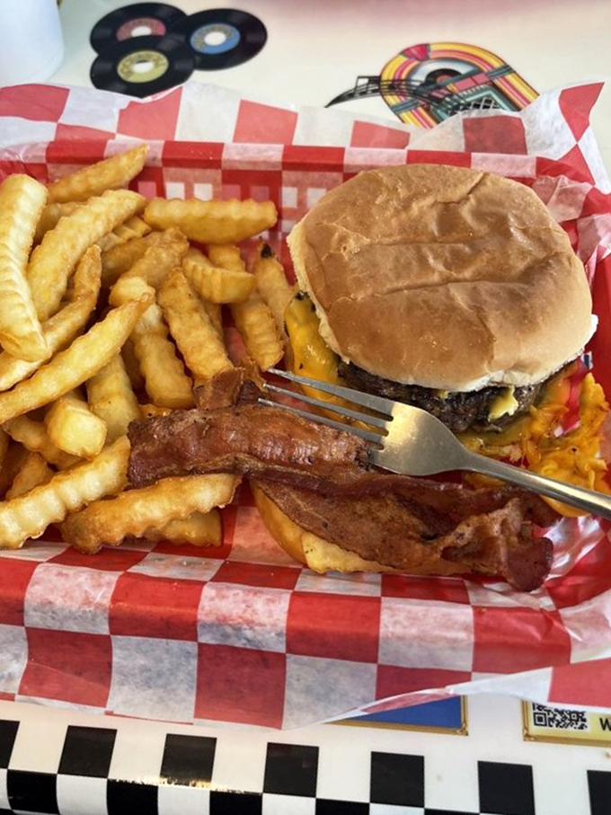 This bacon cheeseburger isn't just a meal; it's a monument to American ingenuity. The fork is merely a suggestion.