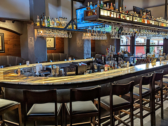 The wraparound bar beckons with polished surfaces and enough spirits to fuel any great dining adventure.