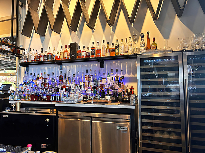 A bar backdrop that turns bottle-browsing into an architectural experience. That diagonal wooden wall isn't just design—it's conversation-starting genius.