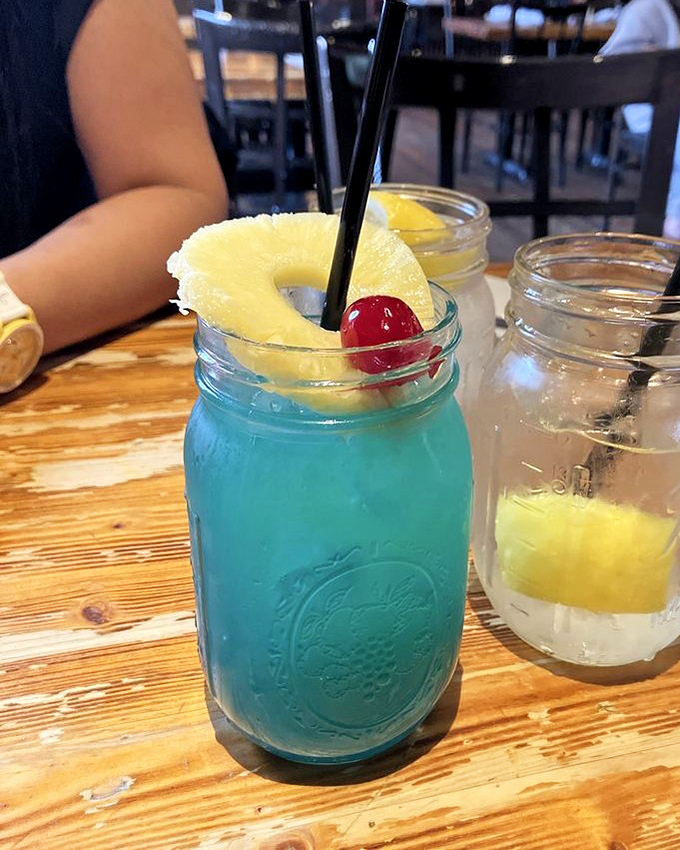The Blue Bayou cocktail&mdash;electric blue and vacation-ready. This mason jar of tropical escape comes with a pineapple life preserver and cherry on top.