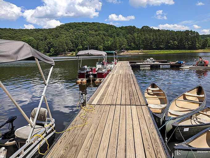 The wooden dock stretches toward adventure like a welcome mat to the lake. These canoes aren't just boats&mdash;they're tickets to exploration.