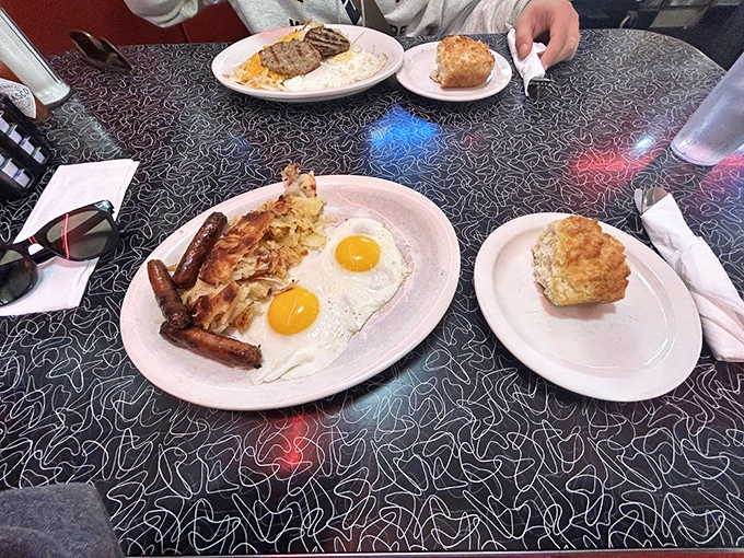 The breakfast platter that answers "yes" to the question "Can I have everything?" Sunny-side eggs, golden hash browns, and sausage links create a morning trifecta.