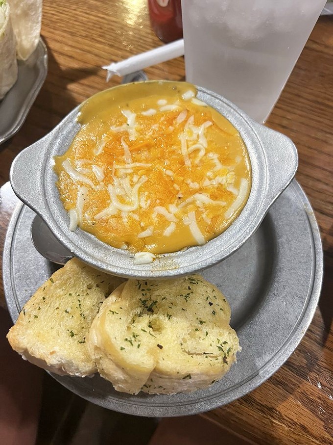 A bowl of sunshine: creamy broccoli and cheese soup with garlic bread for dipping&mdash;comfort food that hugs you from the inside.