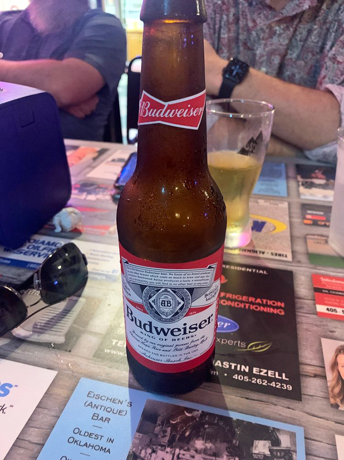 A cold Budweiser awaits its destiny - to meet crispy fried chicken in that perfect blue-collar ballet of flavors.