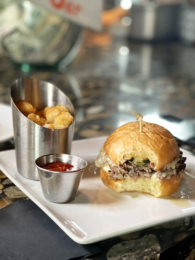 A slider that's dressed for success with perfectly golden tater tots standing guard. This burger doesn't need size to make a mighty impression.