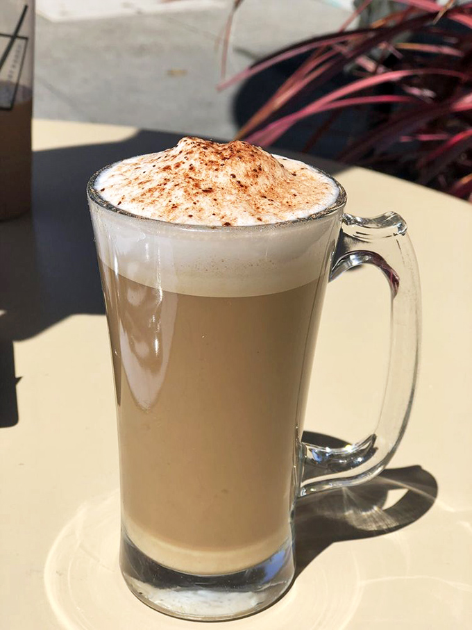 This isn't just coffee&mdash;it's a frothy work of art in a glass mug, dusted with cinnamon like the final touch on a masterpiece.