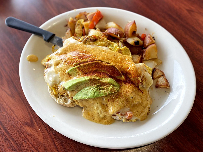 California on a plate! Fluffy scrambled eggs adorned with fresh avocado slices—sunshine in food form.