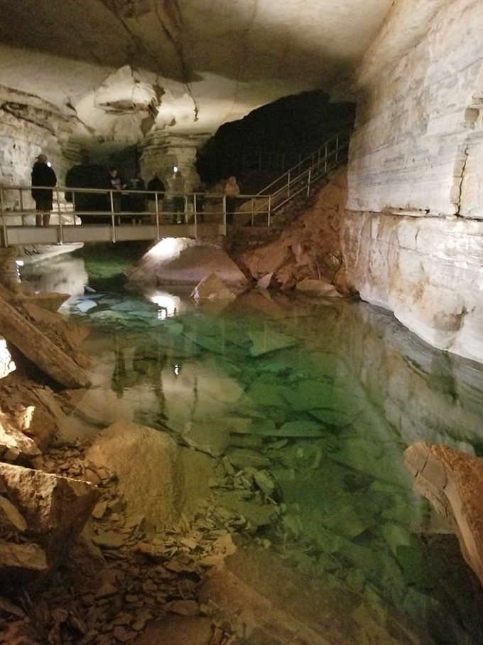 This emerald pool reflects the cavern ceiling like nature's own infinity mirror. The water's so clear you'd think it was photoshopped.