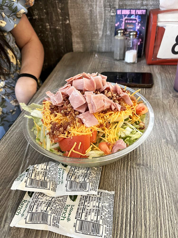 A chef salad that doesn't apologize for its generous portions of ham and cheese—because sometimes "eating light" is just a suggestion.