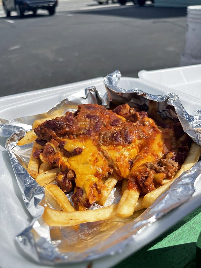 Chili cheese fries served in checkered paper &ndash; because sometimes the messiest foods require the most festive presentation.
