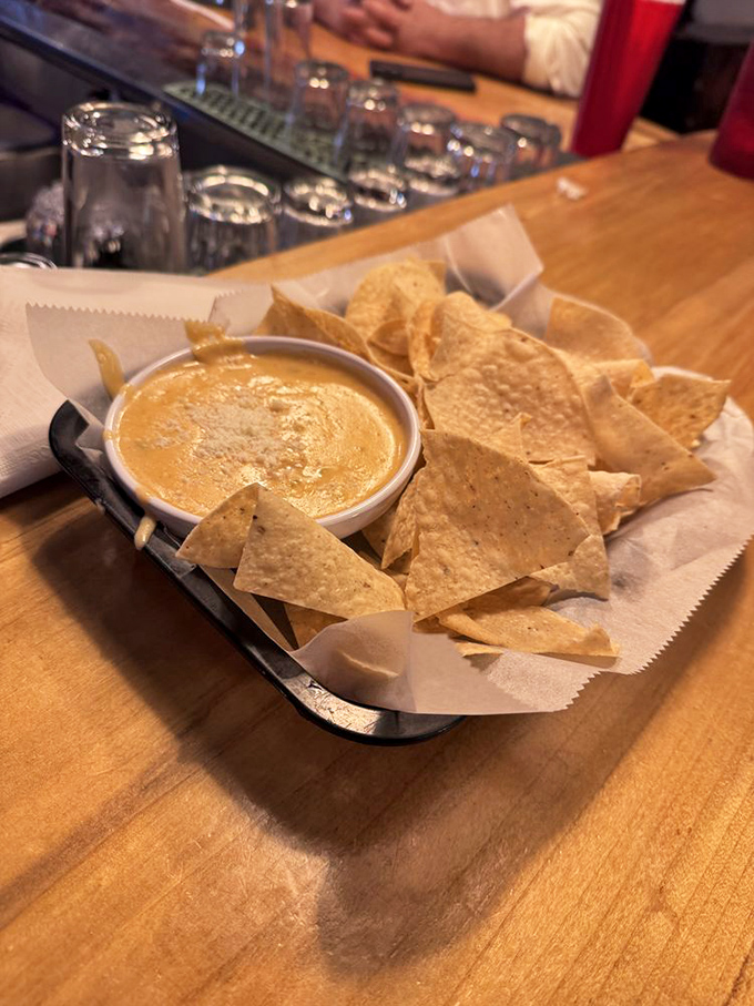 Golden triangles surrounding a pool of liquid gold &ndash; these chips and queso are the opening act that steals the show.