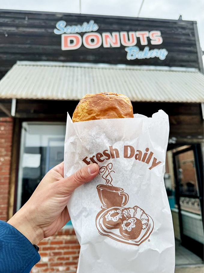 That golden croissant practically whispers "bonjour" from its paper nest, promising flaky layers that shatter delicately with each bite.