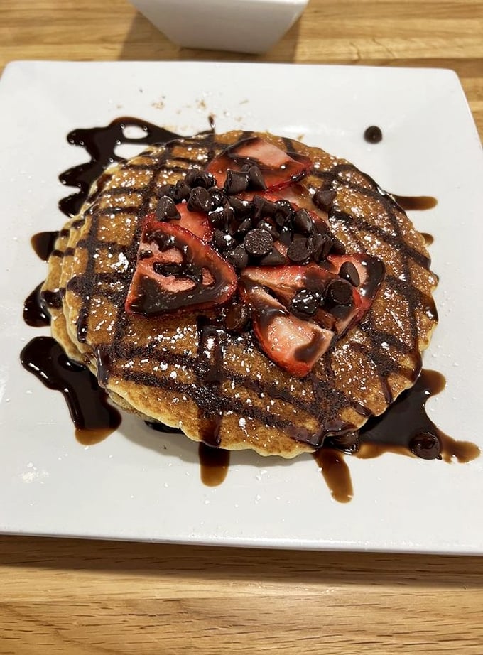 Chocolate chips and strawberries transform an ordinary pancake into something worth setting the alarm for. Breakfast or dessert? Why choose?