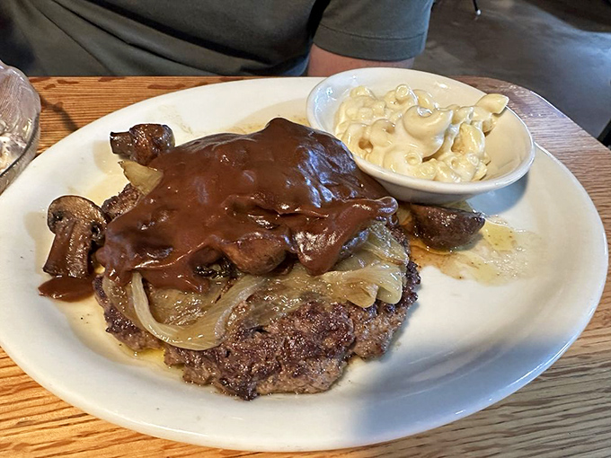 A chopped steak smothered with mushrooms, onions and gravy. When a burger and a steak love each other very much, this is what happens.