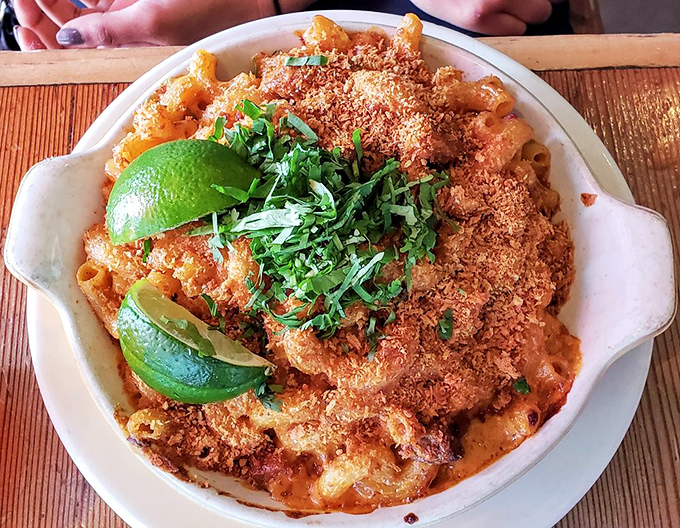 Shredded beef atop creamy mac isn't just a topping&mdash;it's a declaration that comfort food deserves the royal treatment. Green onions add the perfect fresh finish.