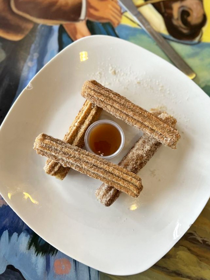 These churros aren't just arranged—they're architecturally designed around honey, creating a sweet little edible Lincoln Log cabin of joy.