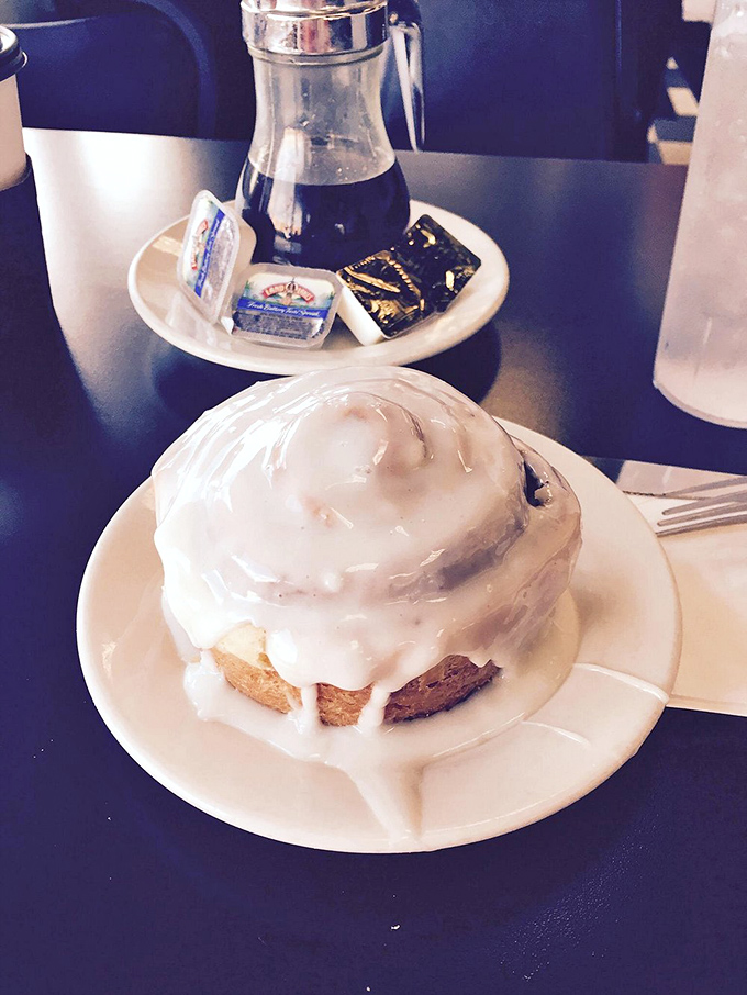 A cinnamon roll that doesn't just suggest indulgence&mdash;it insists upon it. The icing cascades down like a sweet avalanche of morning joy.