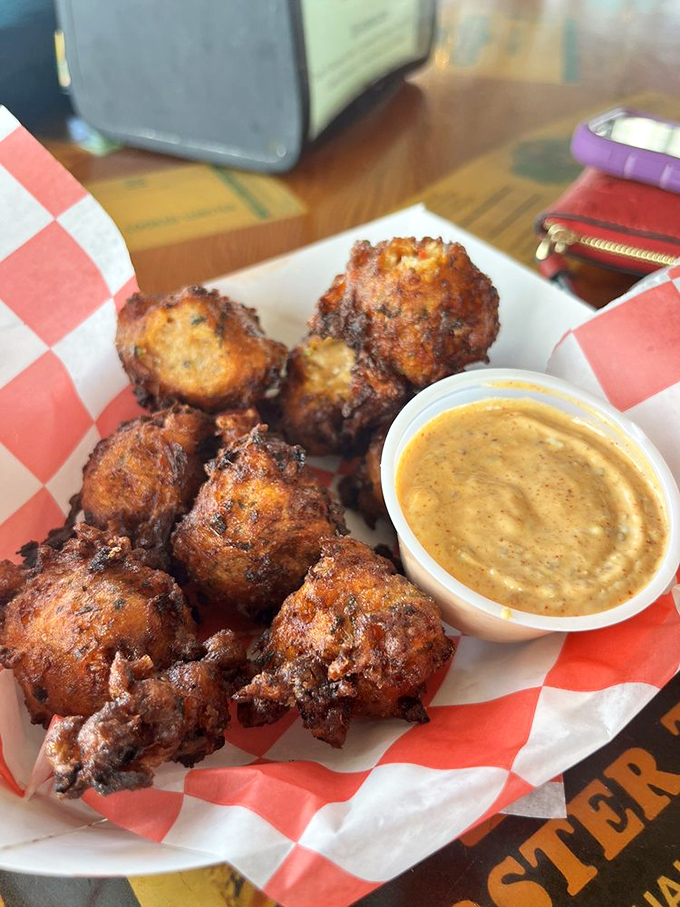 Conch fritters—golden-brown spheres of Keys tradition. These crispy bites are the perfect vehicle for that mustard dipping sauce.