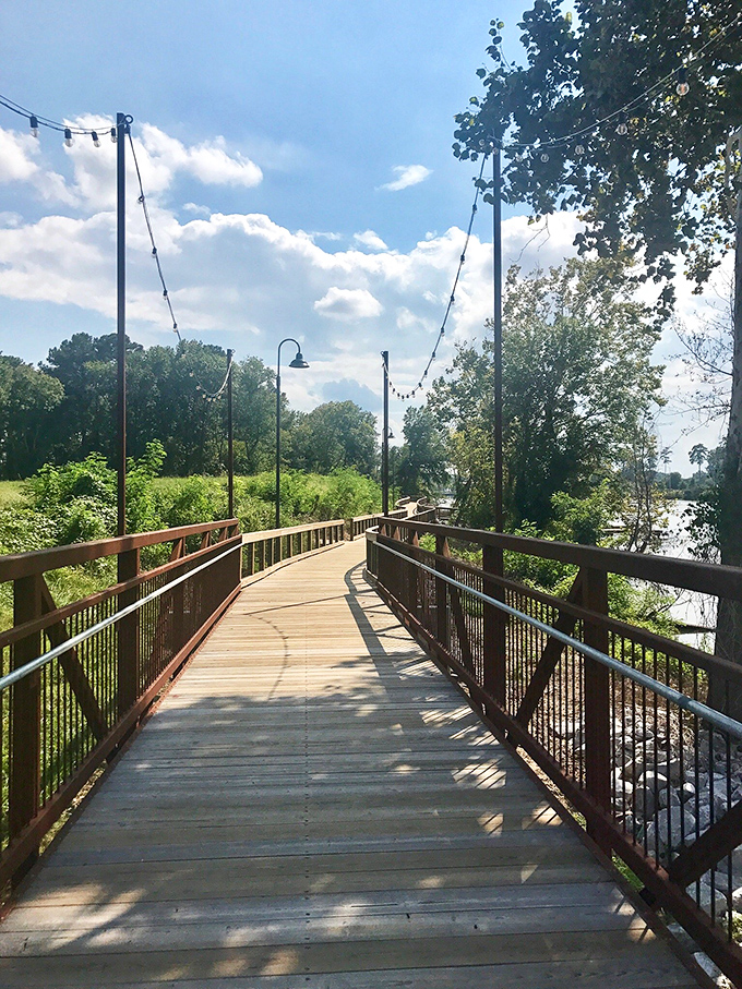 Sunlight dapples this riverside boardwalk, where string lights hint at evening magic to come. Just add acoustic guitar and sunset for peak Southern romance.