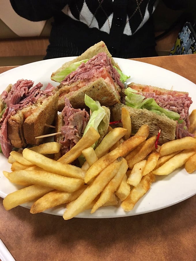 The club sandwich stands tall like a delicious skyscraper of comfort&mdash;corned beef, lettuce, and toast forming a sandwich skyline worth admiring before demolishing.