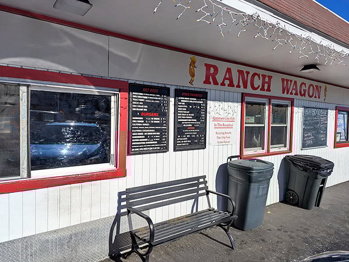 The Ranch Wagon storefront stands ready for service, a bench patiently waiting for those who arrive early or linger after satisfaction.