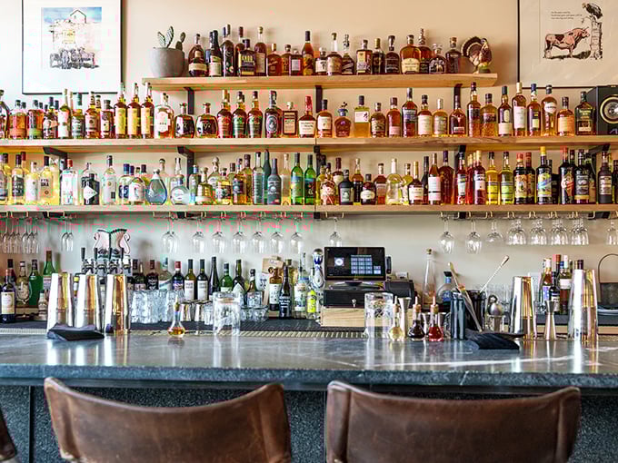 The bar showcases an impressive spirits collection that would make any whiskey enthusiast weak in the knees.