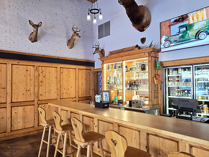 The rustic bar area, complete with mounted deer heads, channels a Bavarian hunting lodge where thirst goes to surrender to excellent German beer.