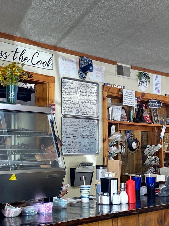 The "Kiss the Cook" sign isn't just cute decor&mdash;it's sound advice after experiencing what happens behind that counter.