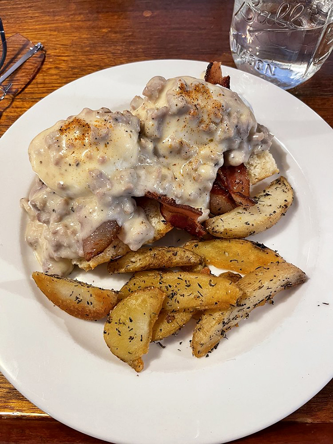 This isn't just breakfast, it's a monument to morning indulgence &ndash; eggs and biscuits baptized in gravy that could make a vegetarian reconsider.