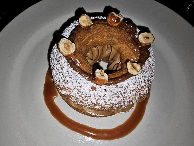 This hazelnut dessert with its powdered sugar crown and caramel moat is basically royalty on a plate. Bow down accordingly.