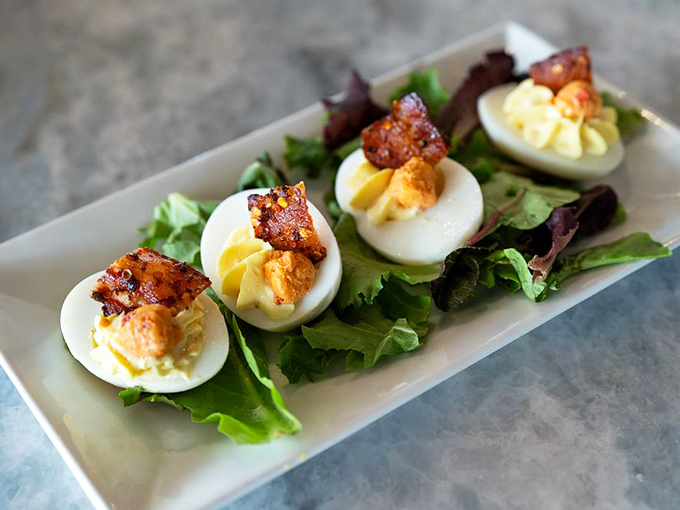Deviled eggs topped with crispy bacon—proof that sometimes the simplest pleasures are the most devilishly satisfying.