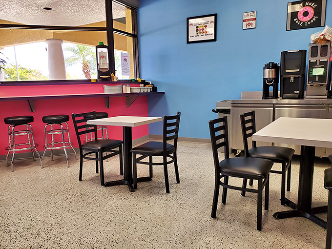 Simple seating against vibrant walls&mdash;because they know you're here for the donuts, not the d&eacute;cor. Though the color scheme certainly wakes you up.