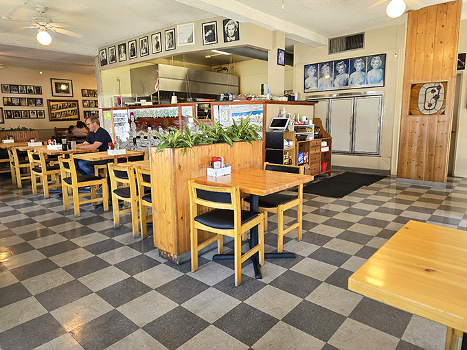 The checkered floor and wooden tables create that classic diner atmosphere where strangers become friends over shared appreciation of perfectly cooked eggs.